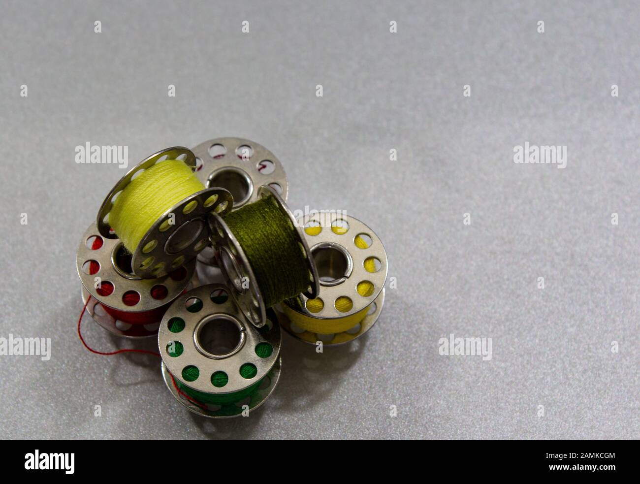 Yarn coils of a sewing machine with different yarn colours Stock Photo ...
