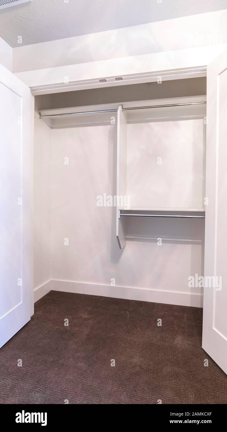 Vertical Open door of an empty clothes closet Stock Photo - Alamy