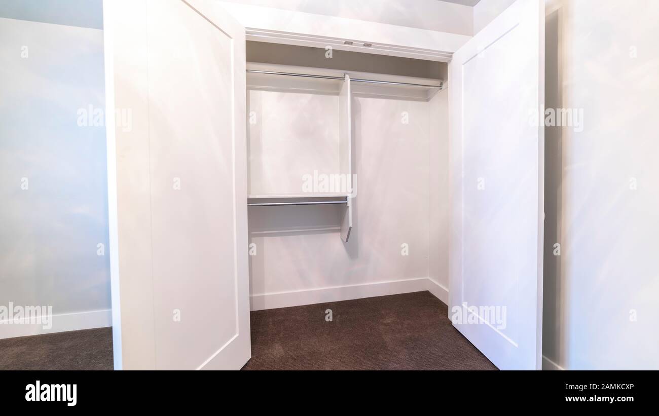 Panorama frame Open door of an empty clothes closet Stock Photo - Alamy