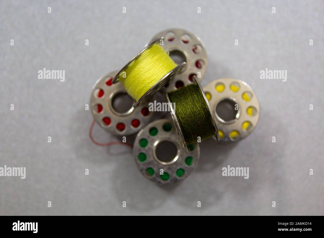 Yarn coils of a sewing machine with different yarn colours Stock Photo ...