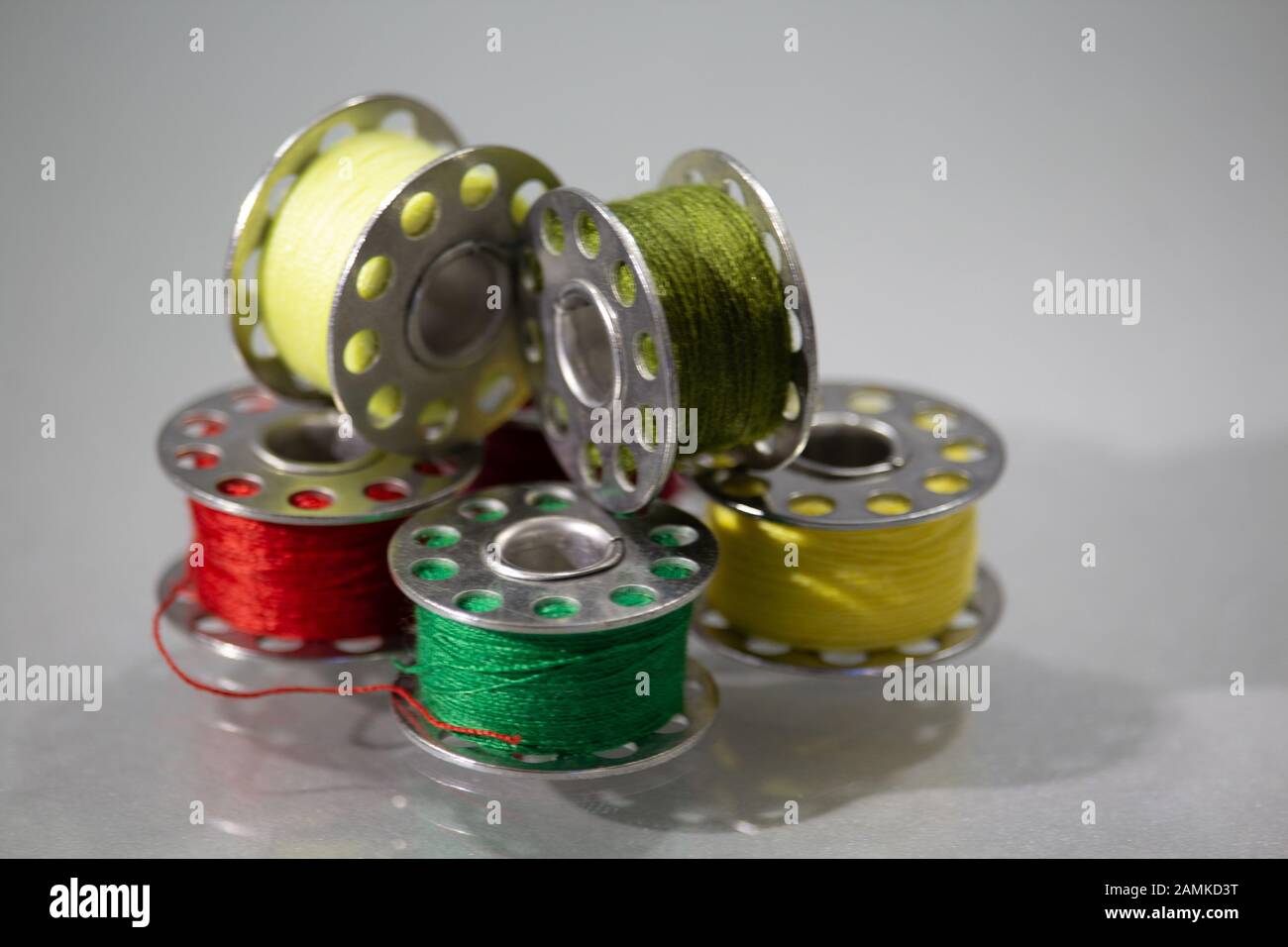 Yarn coils of a sewing machine with different yarn colours Stock Photo ...
