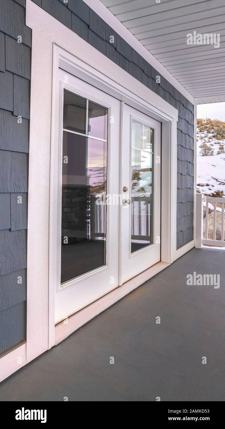 Vertical frame View from a covered front veranda of winter snow Stock ...