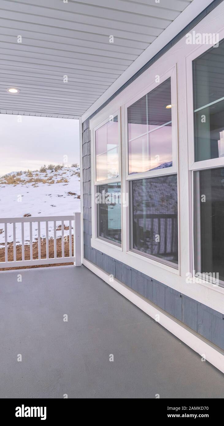 Vertical frame Long covered patio with large glass windows Stock Photo ...