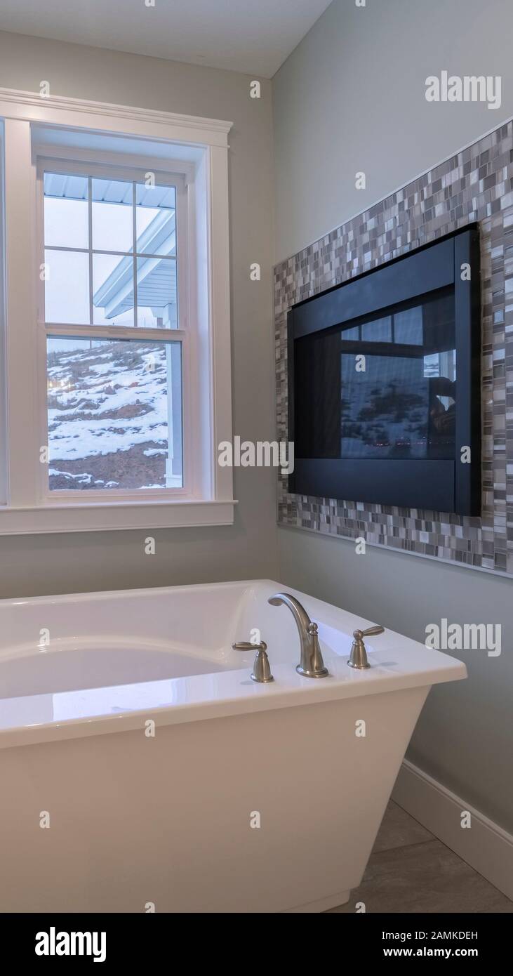 Vertical Small compact bathtub in a modern bathroom Stock Photo - Alamy