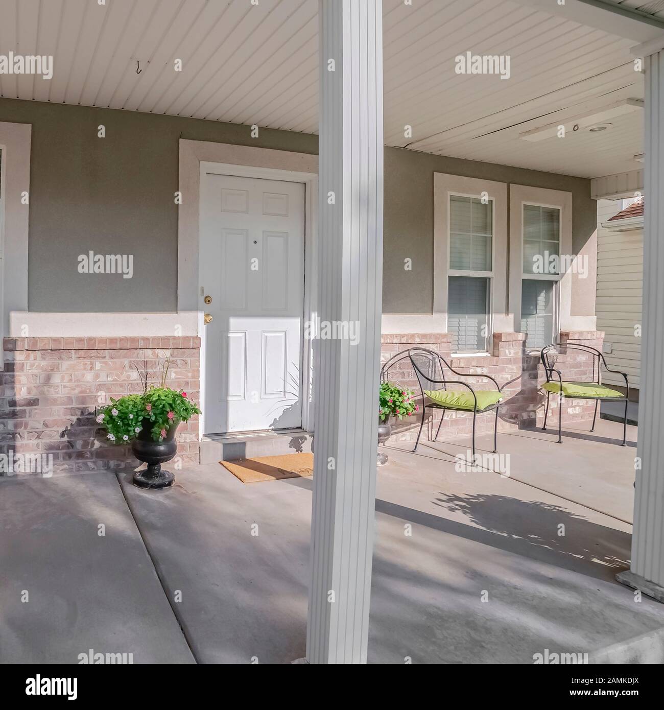 Square Covered veranda with chairs and front door Stock Photo - Alamy