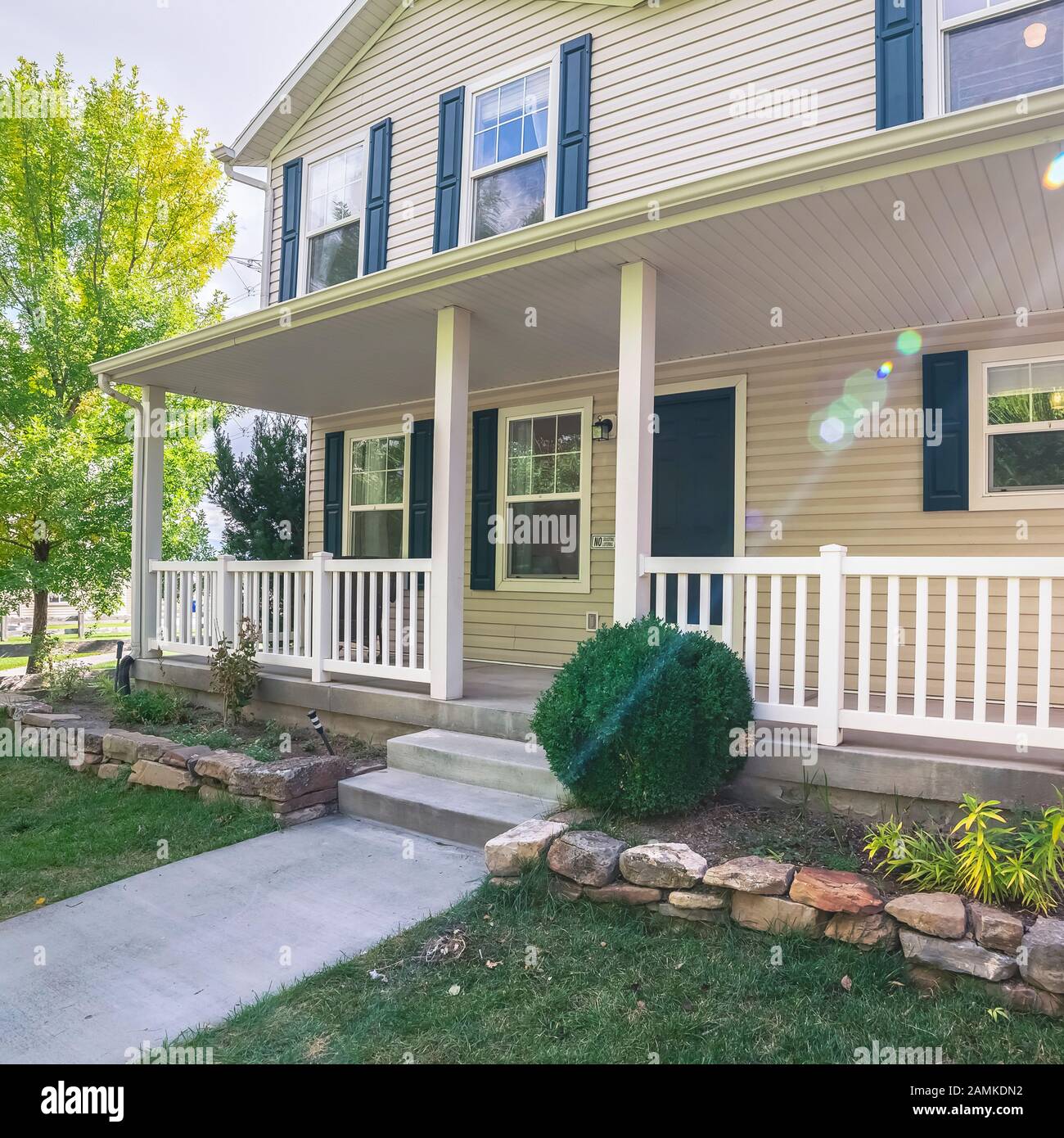 Square White timber house with shutters and veranda Stock Photo - Alamy