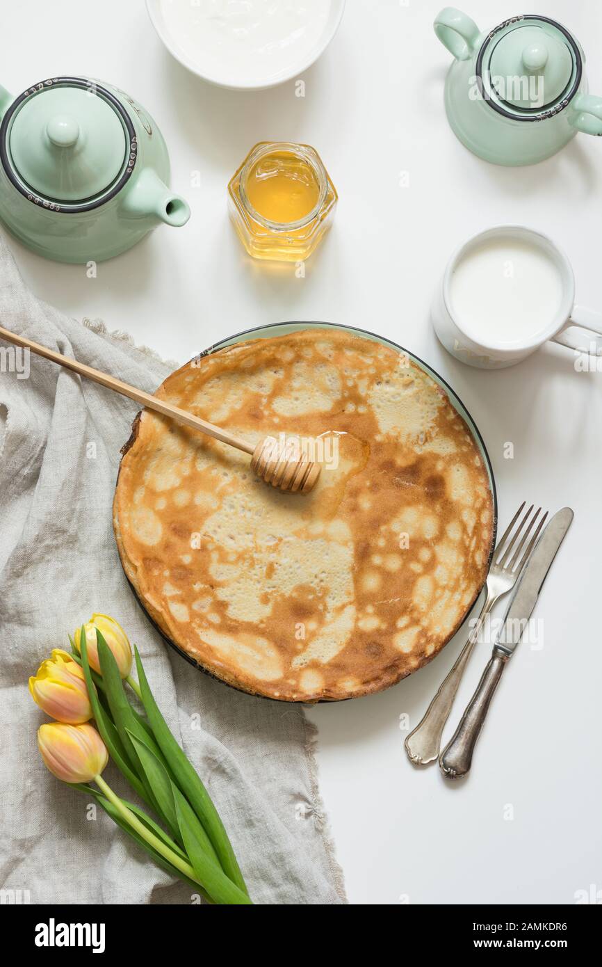 Tasty traditional russian breakfast pancakes, blini, sour cream, milk ...