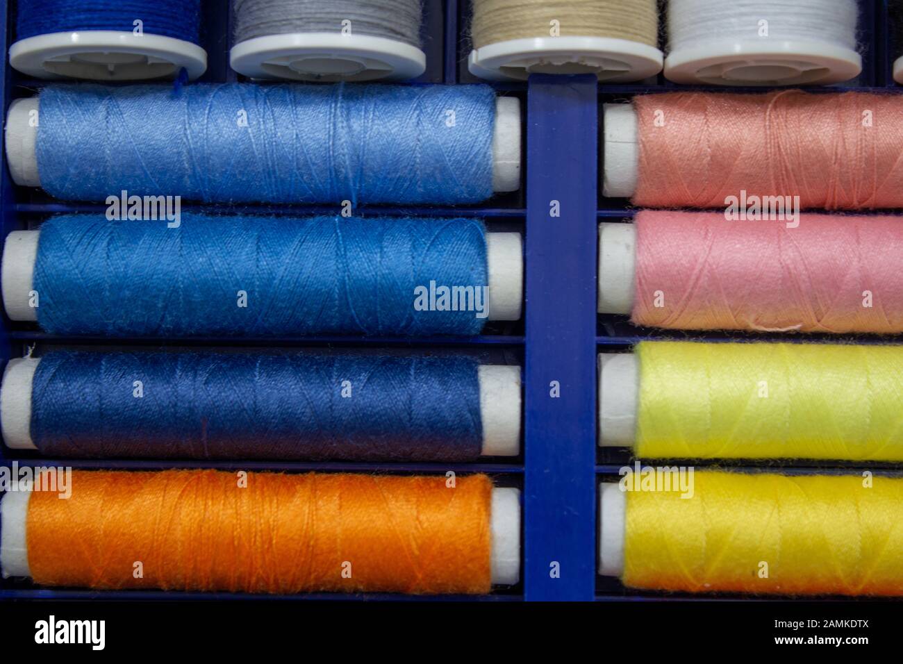 Yarn coils of a sewing machine with different yarn colours Stock Photo ...