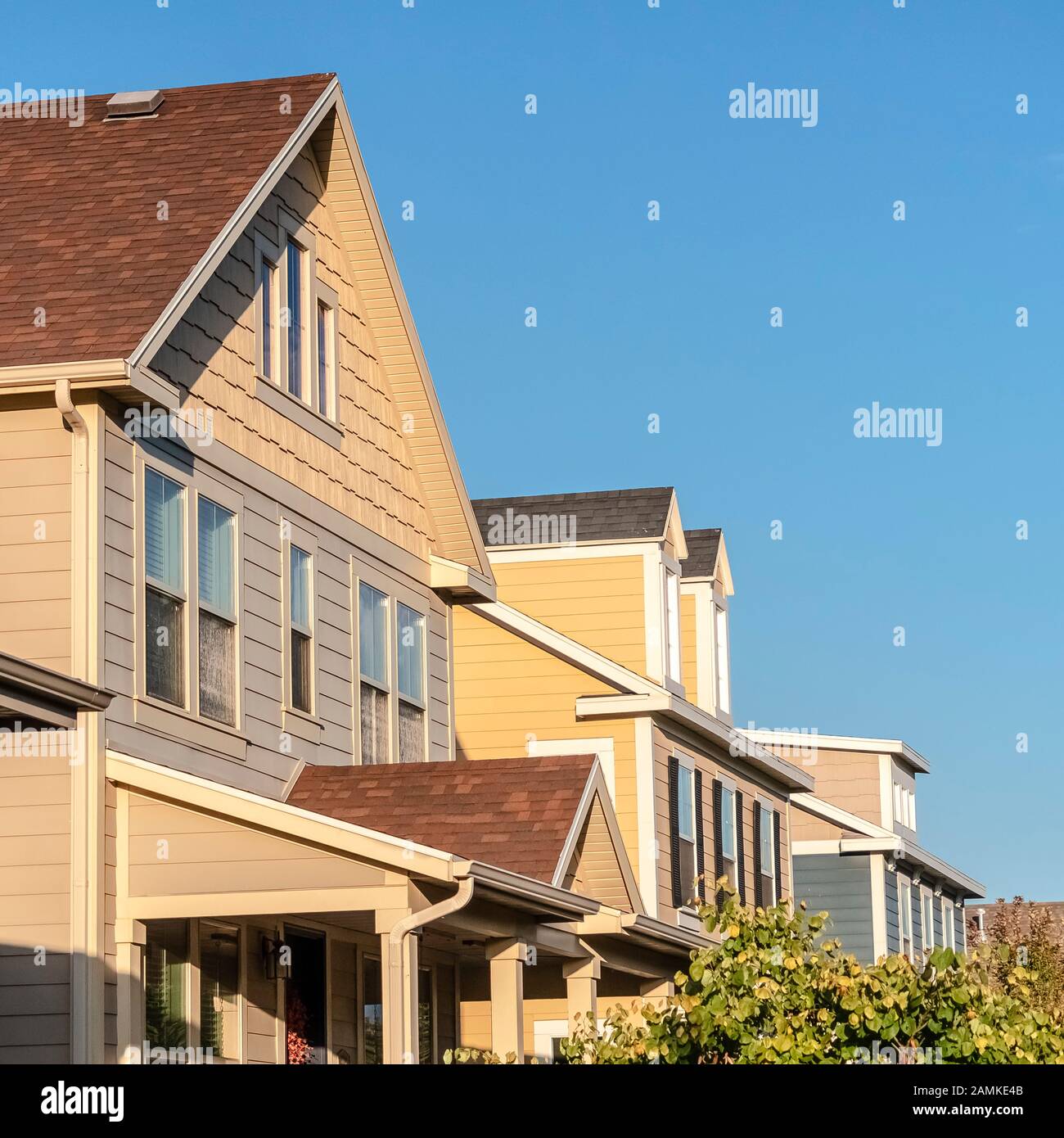Square Row of double storey timber clad homes Stock Photo - Alamy