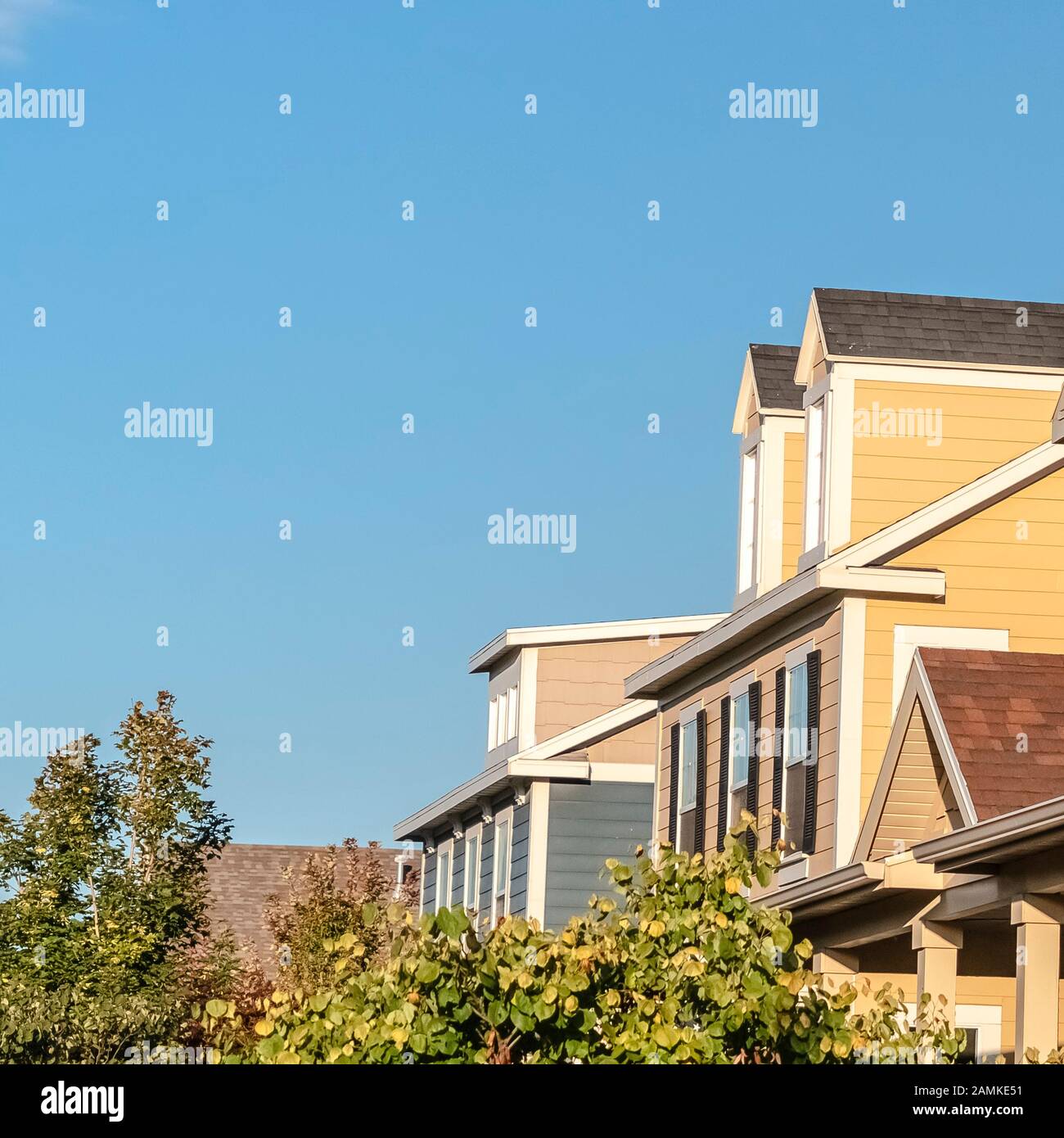 Square frame Row of double storey timber clad homes Stock Photo - Alamy
