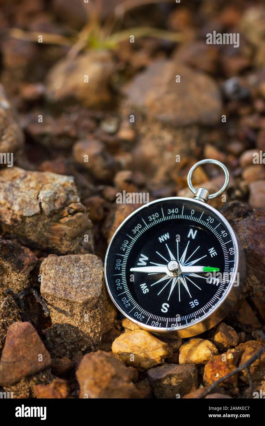 Compass placed on the rock in forest. Closeup and copy space. Concept ...