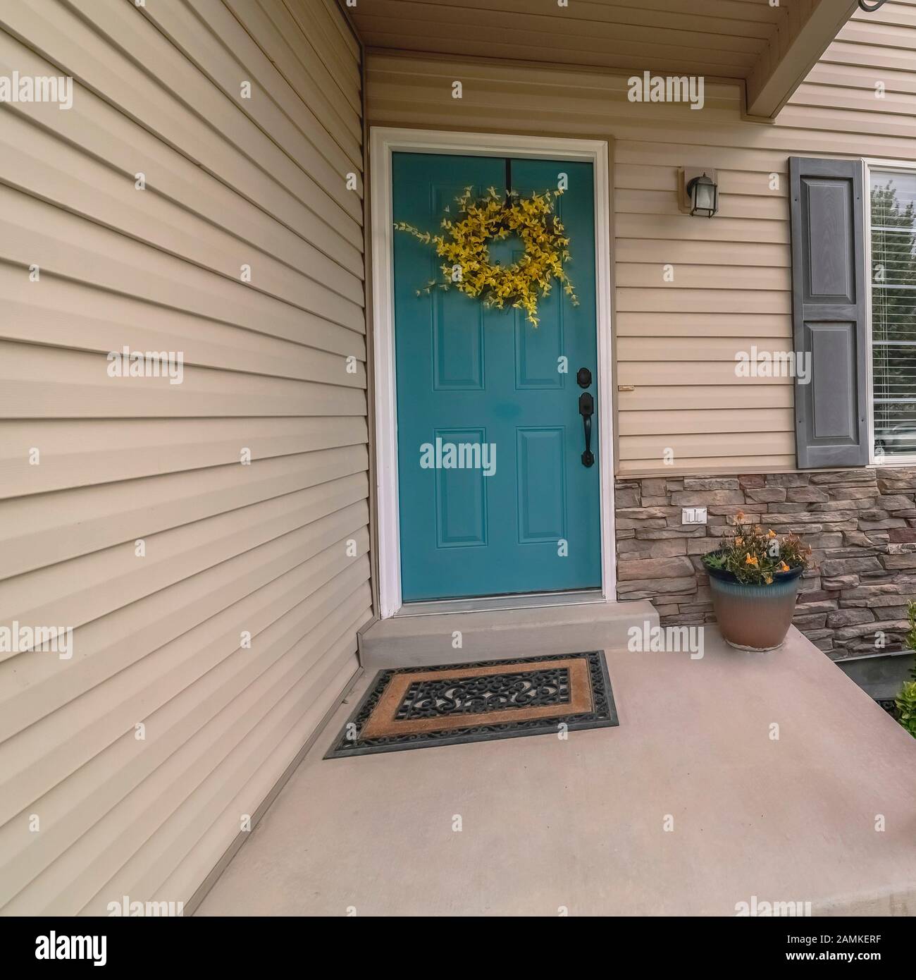 Square Colorful blue wooden front door with wreath Stock Photo - Alamy