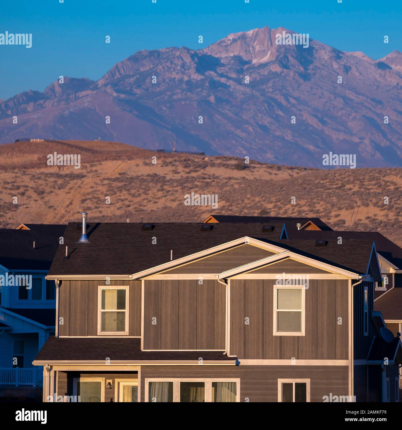 Square frame Brown urban house with mountain backdrop day light Stock ...
