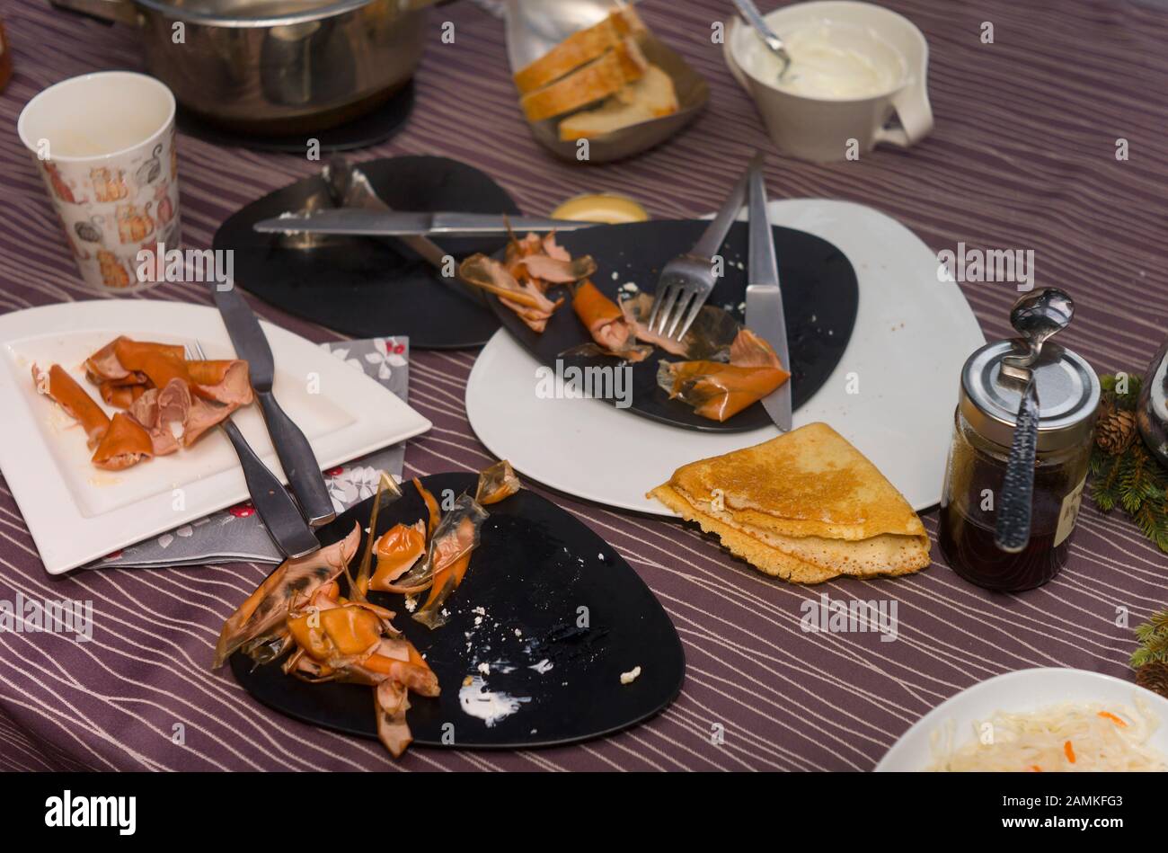 Dining table abandoned in complete mess after lunch, shallow depth of ...