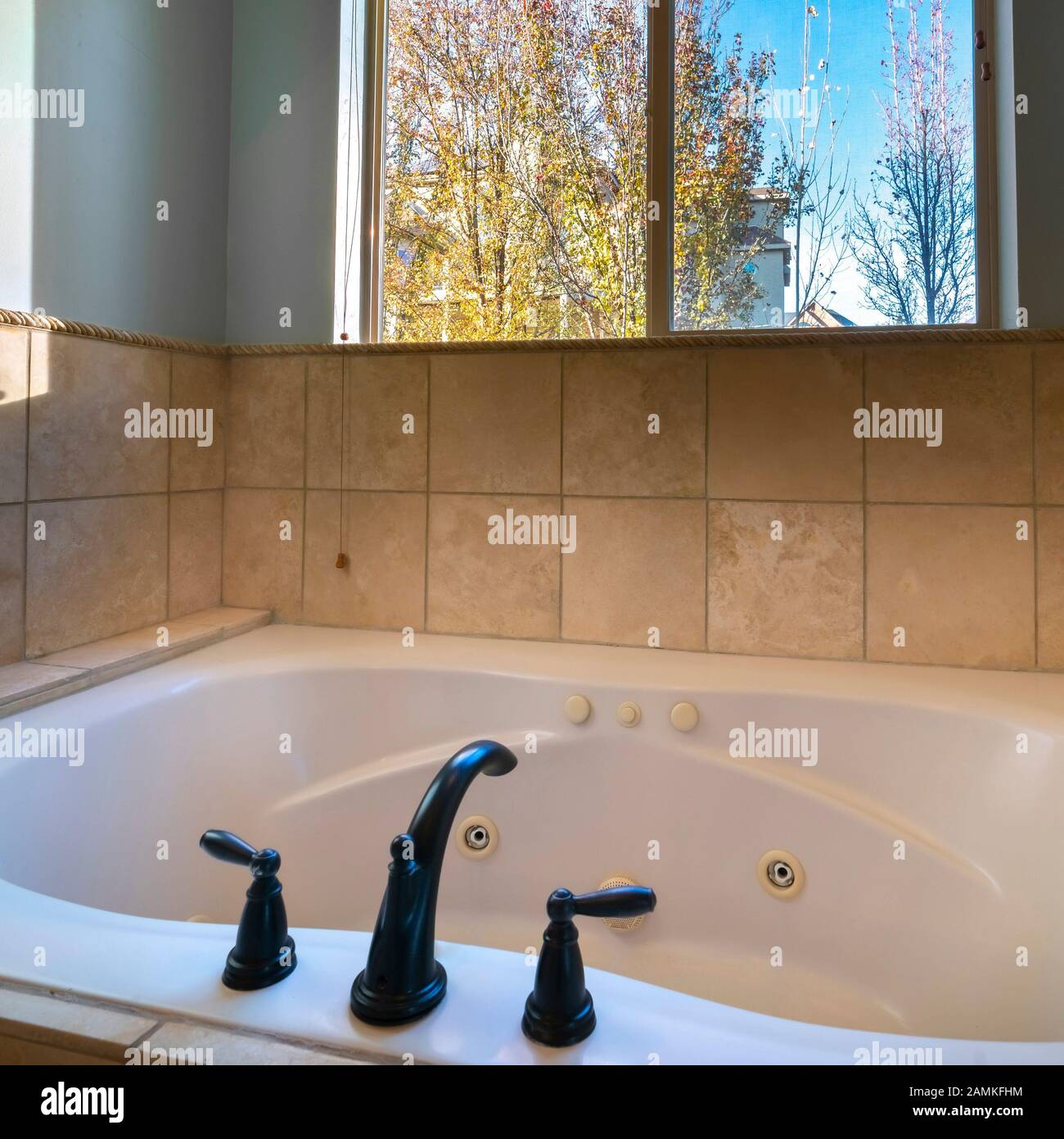 Square Small luxury spa bath in a tiled modern bathroom Stock Photo - Alamy