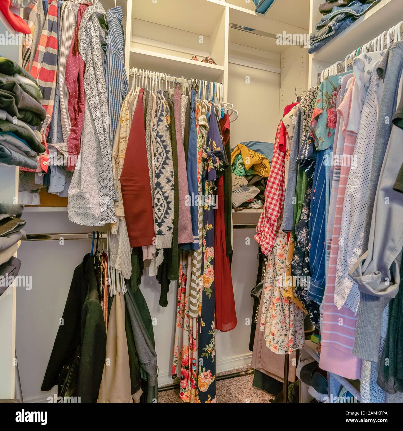 Square Clothing hanging up in a walk-in closet Stock Photo - Alamy