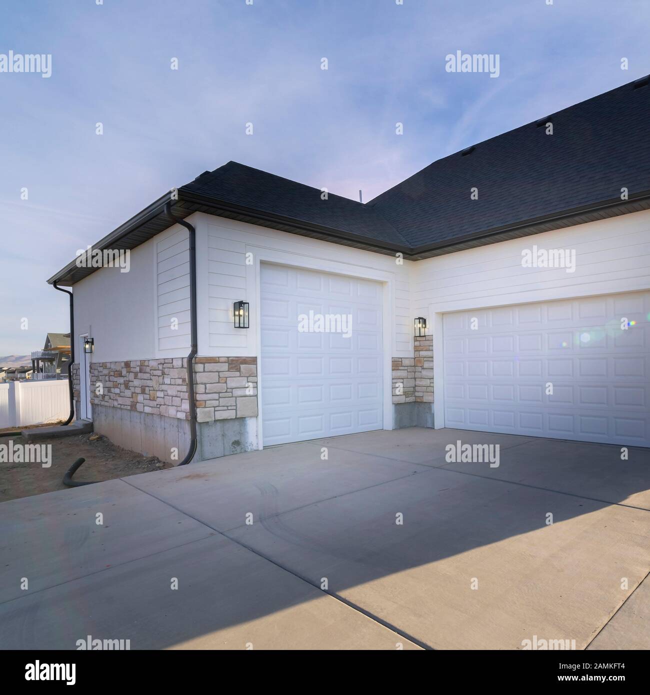 Square frame Two garages with paved forecourt and white doors Stock ...