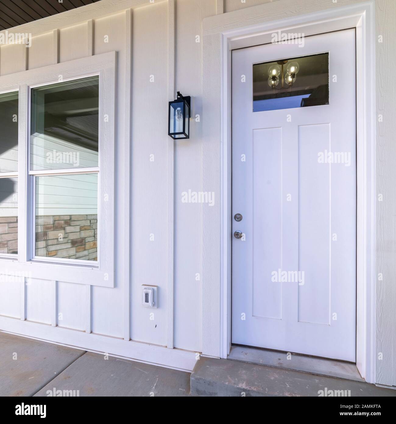 Square frame Large square window alongside a white door Stock Photo - Alamy