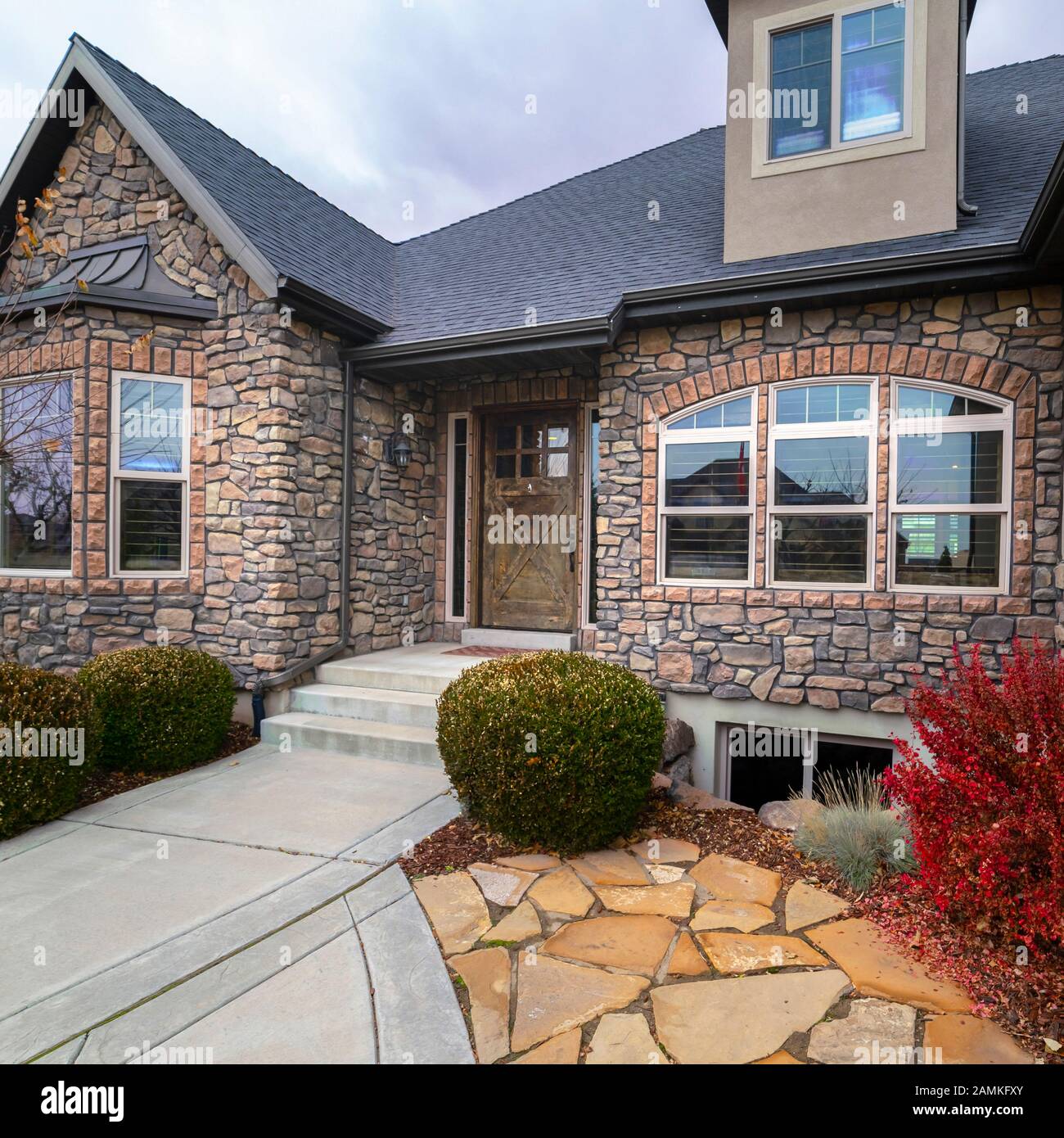 Square Neat front footpath and garden to an urban home Stock Photo - Alamy