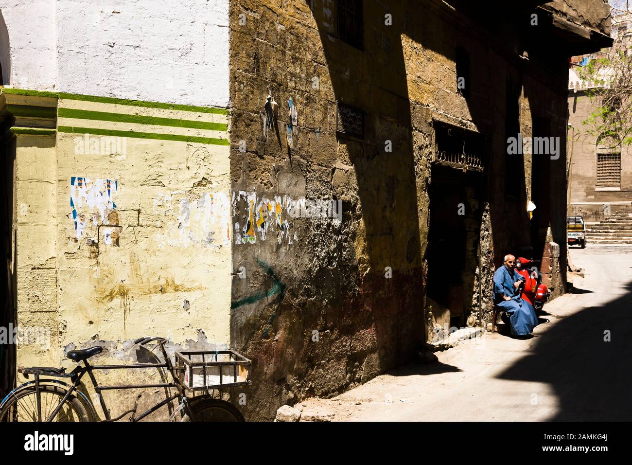 Man sitting on alley of old Cairo, islamic area, Egypt, North Africa ...