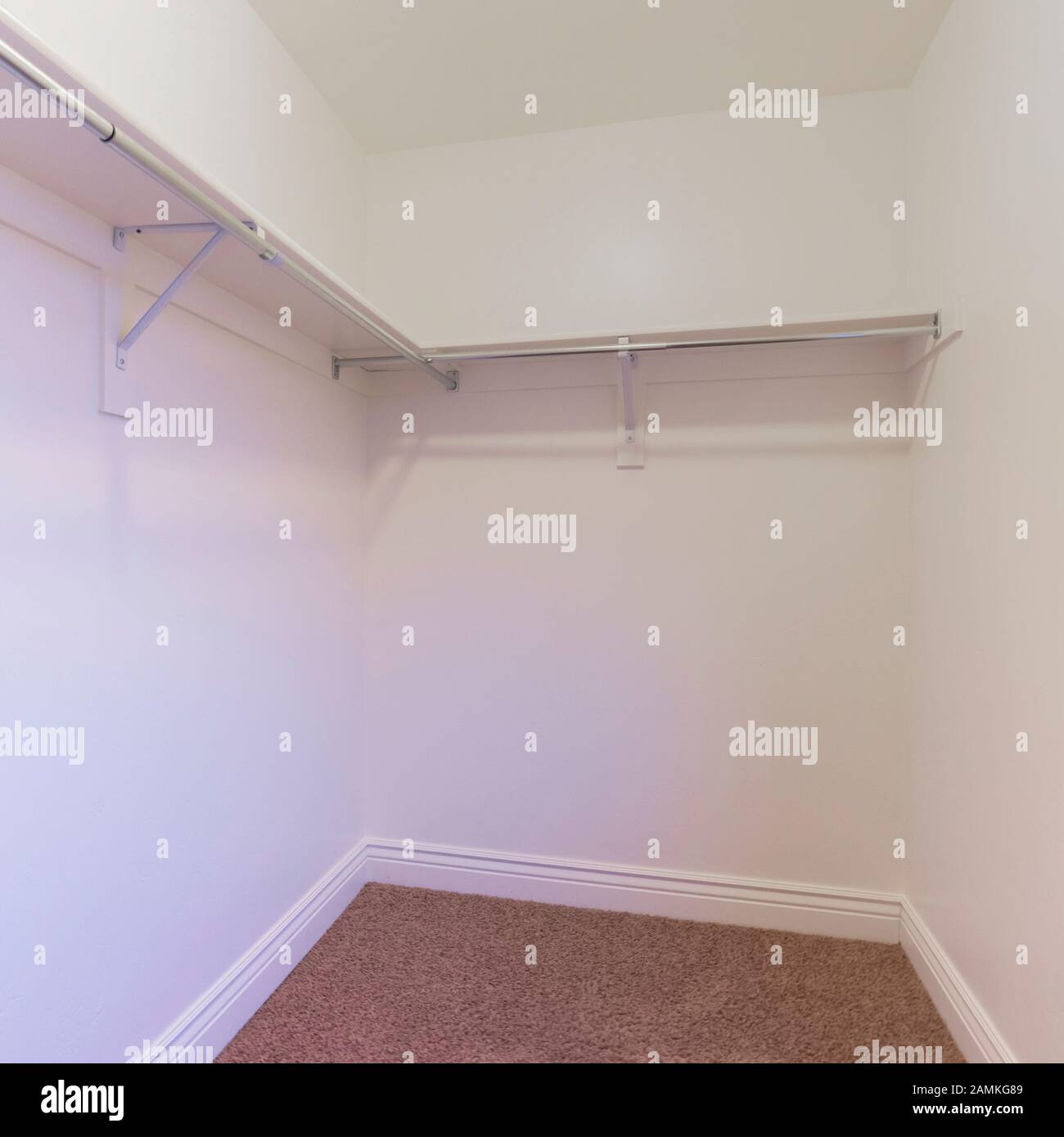 Square Interior of empty walk-in wardrobe with rails Stock Photo - Alamy