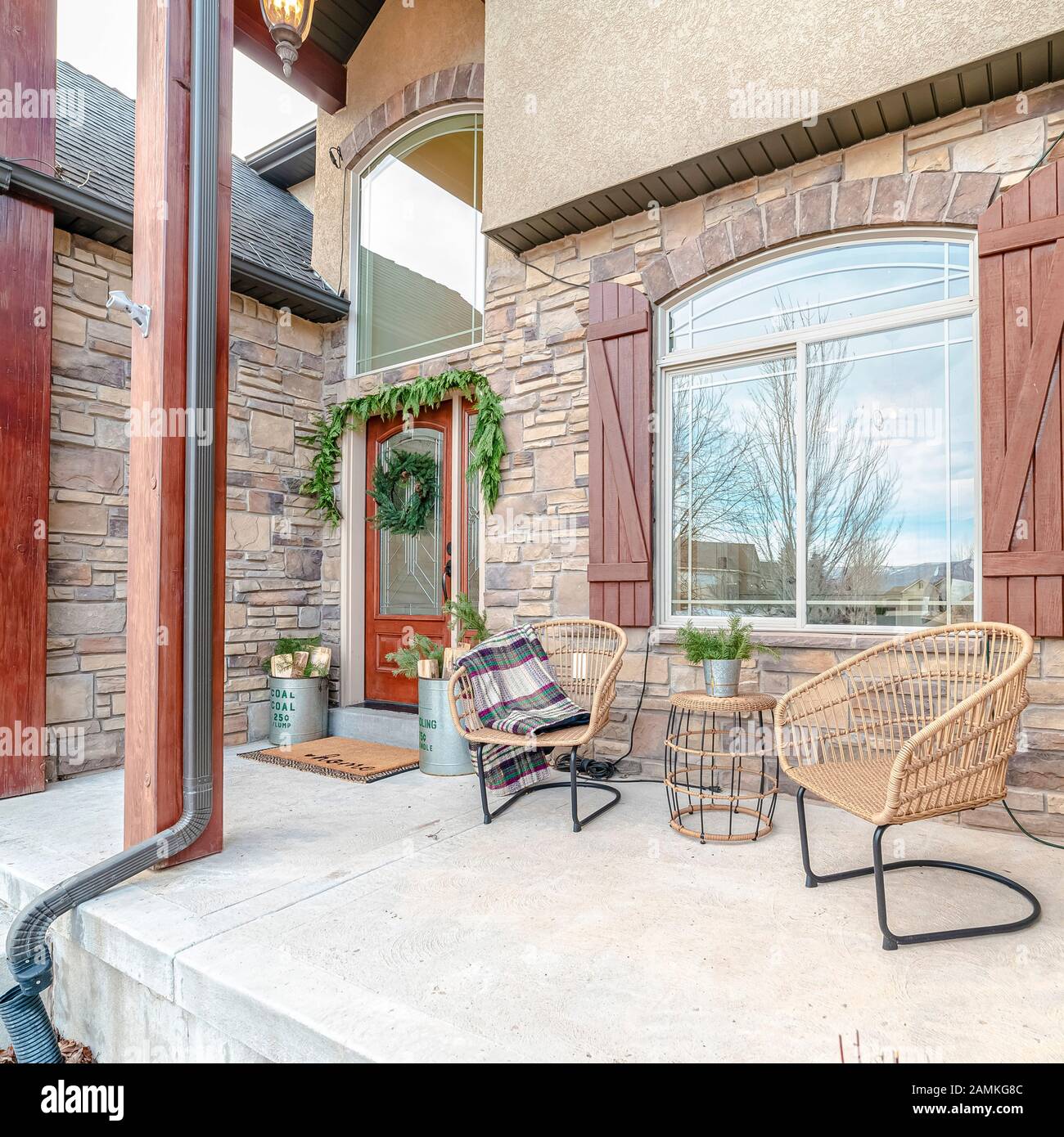 Square Exterior patio with two wicker comfy chairs Stock Photo - Alamy