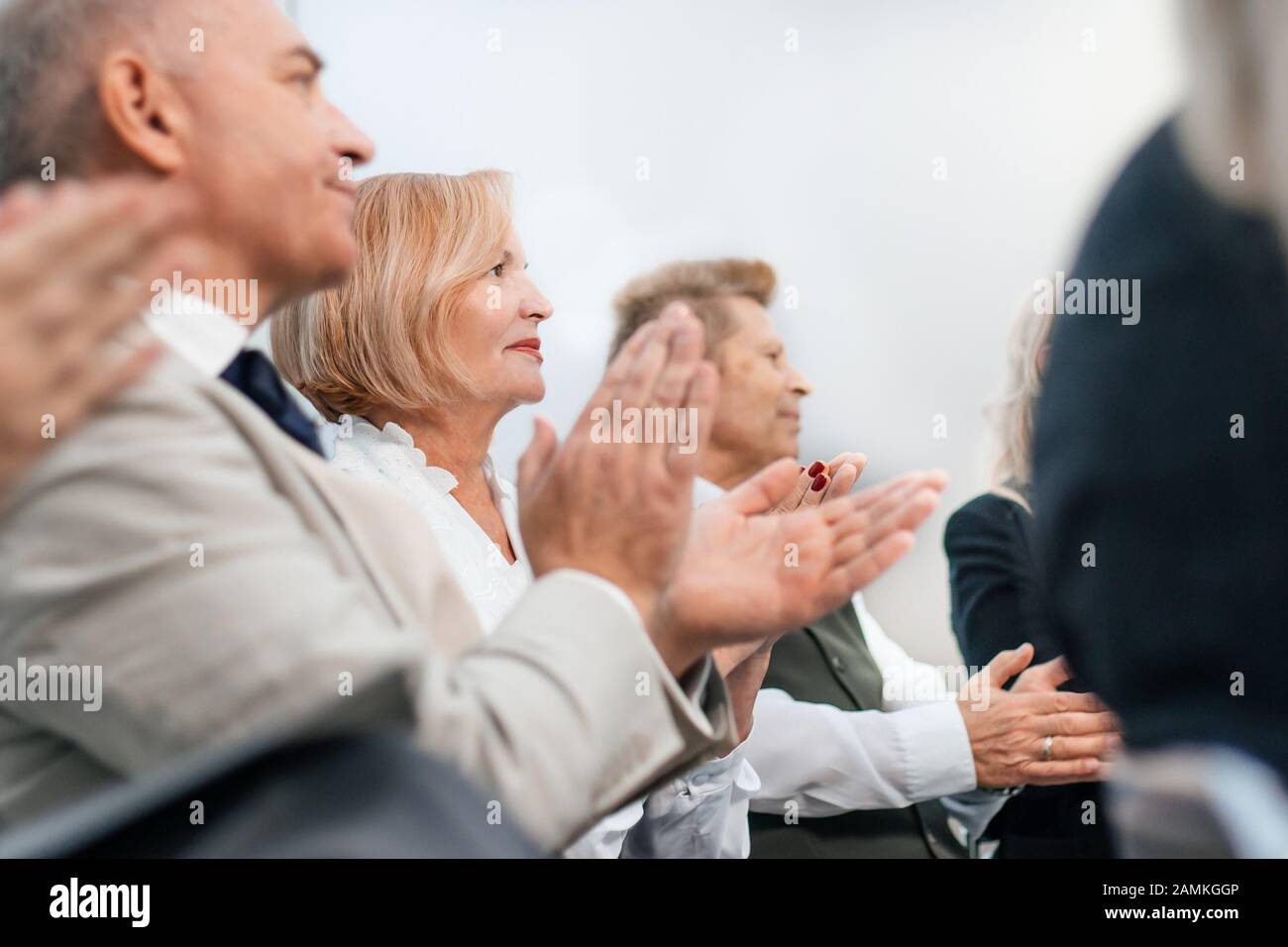 Businesswomen clapping in conference room hi-res stock photography and ...
