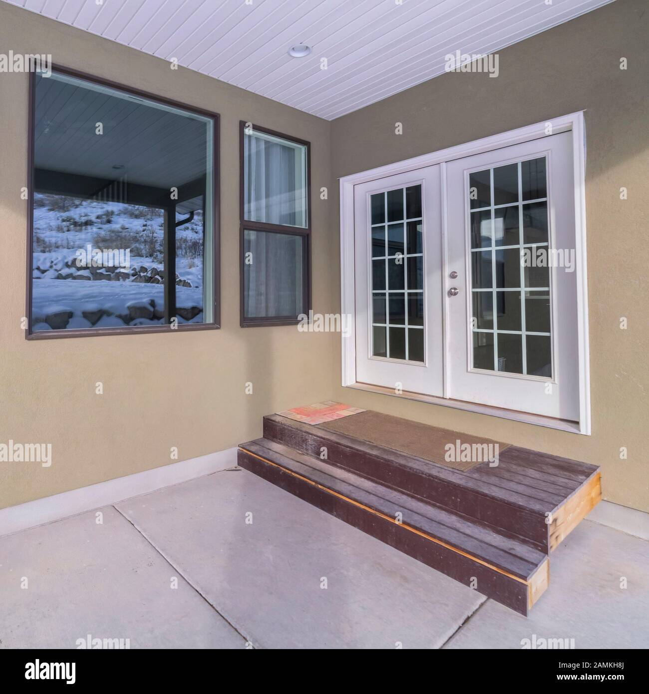 Square Double glass cottage pane doors opening onto patio Stock Photo ...