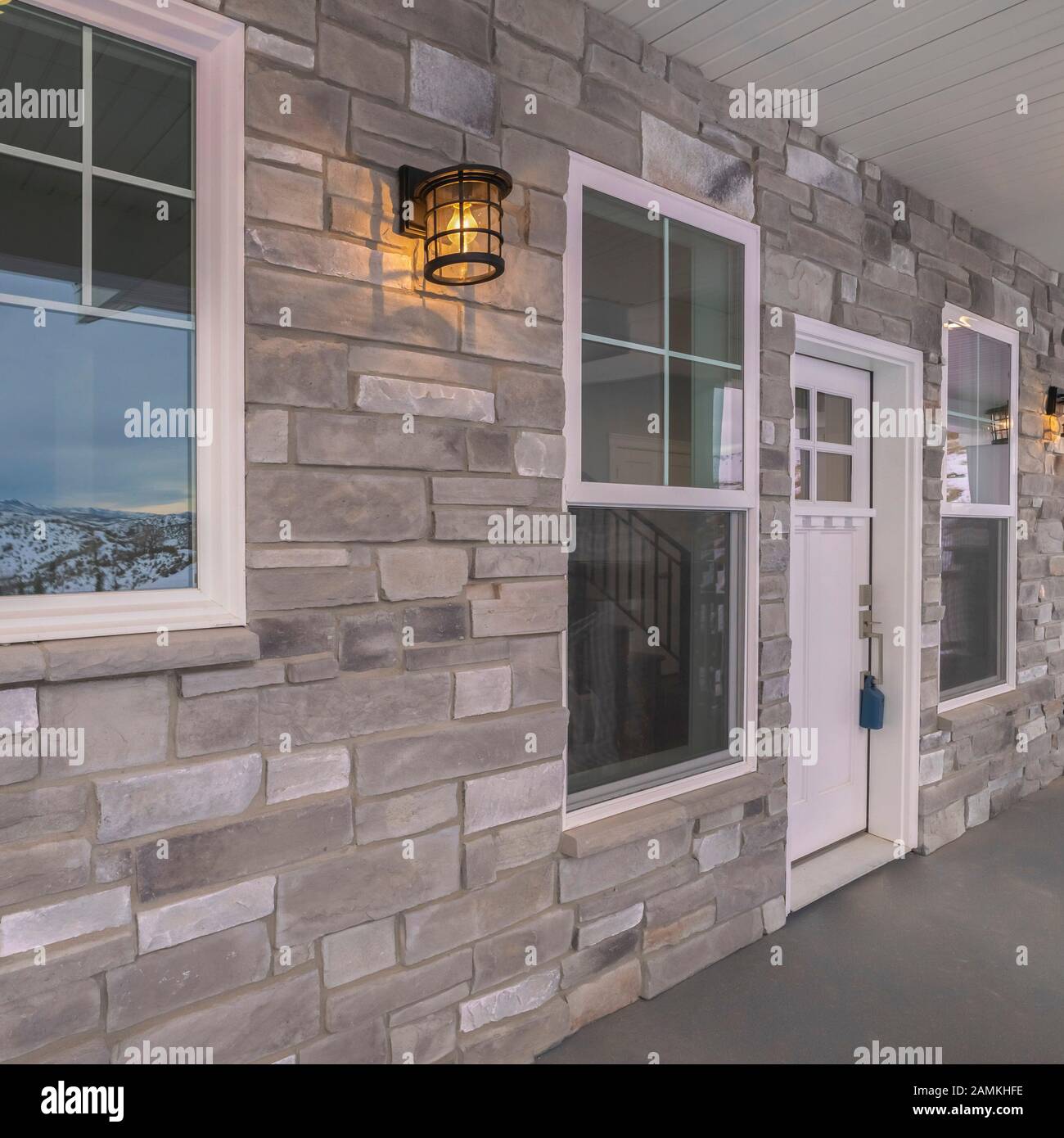 Square View along a feature brick wall of a modern house Stock Photo ...