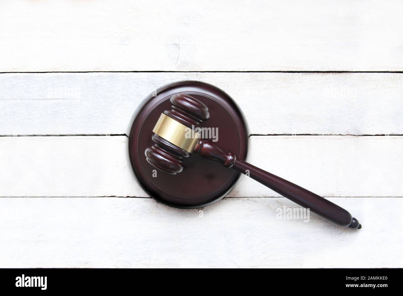 Justice mallet on a white wooden desk in a courtroom during a judicial ...