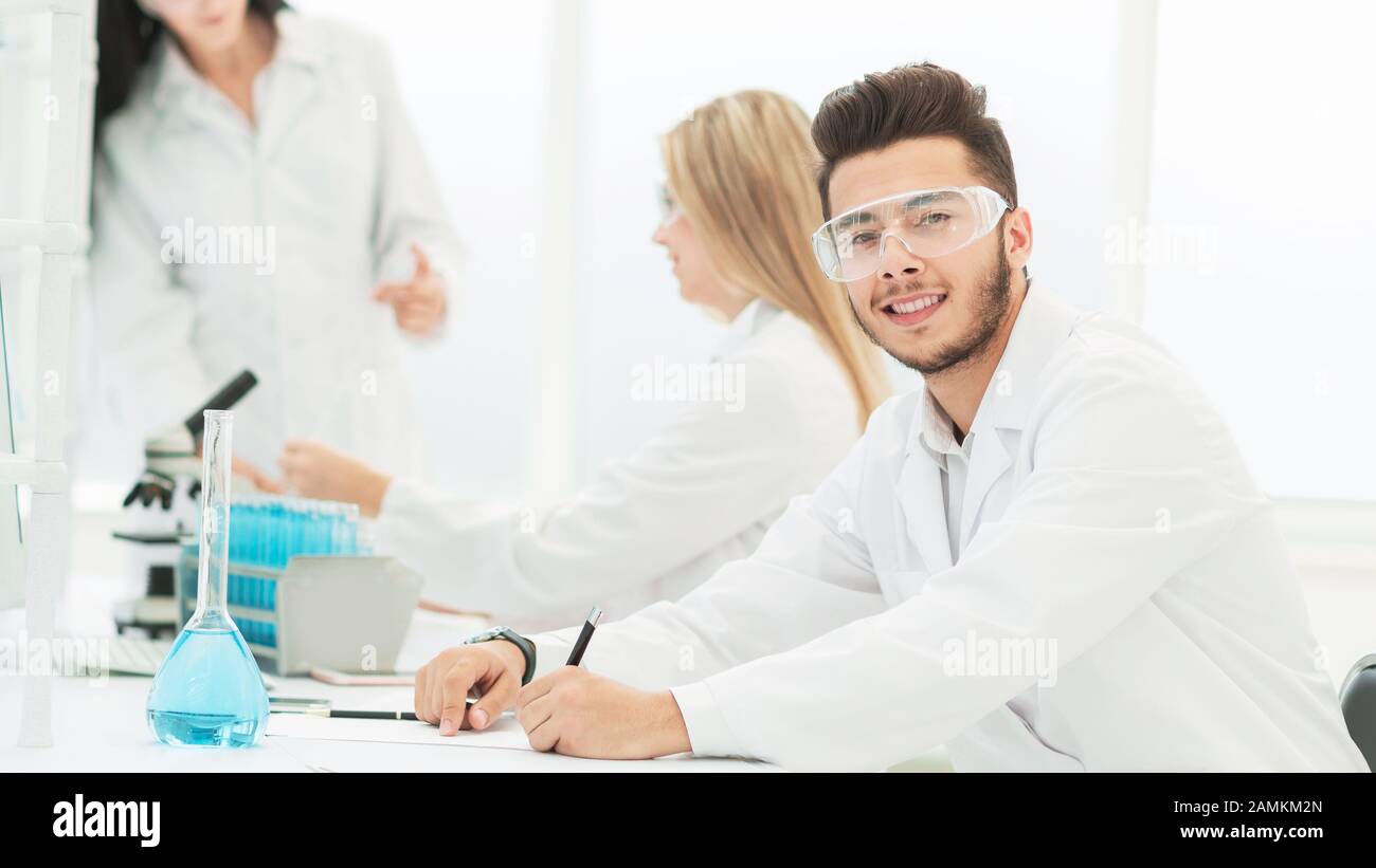 close up.young scientist sitting at his Desk in the laboratory Stock ...