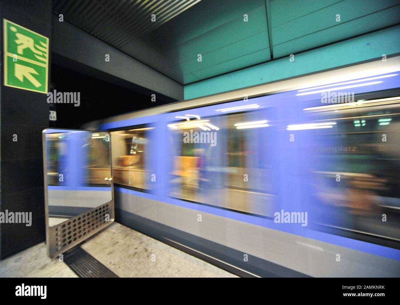 A departing underground train is reflected in the safety mirror at the ...