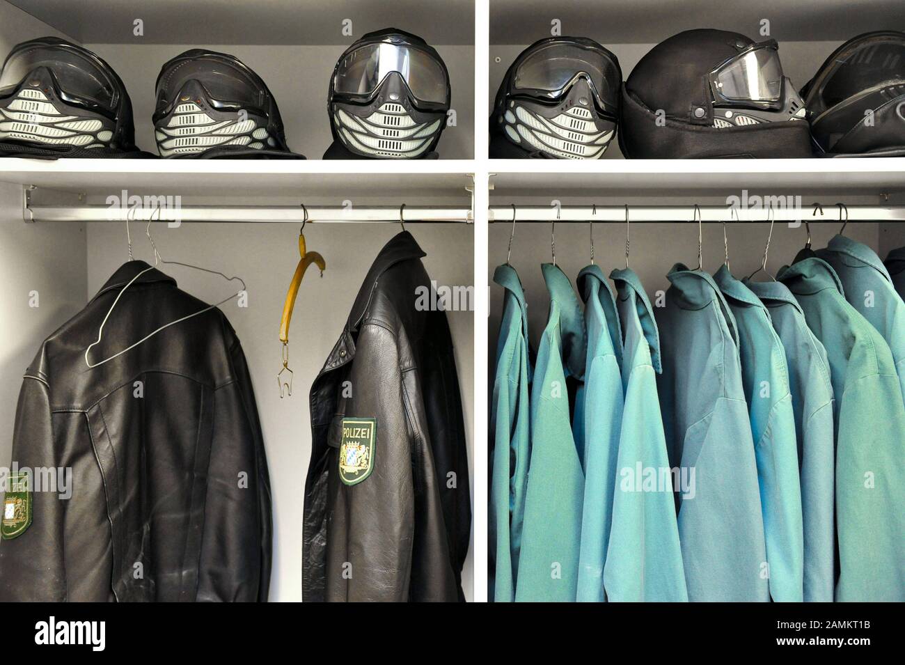 Police jackets and shirts hung up in the closet. Helmets are on a shelf ...