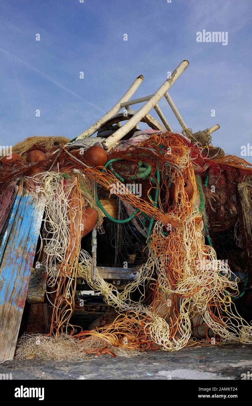 Clutter of fishing nets at the harbour near Corricella. [automated ...