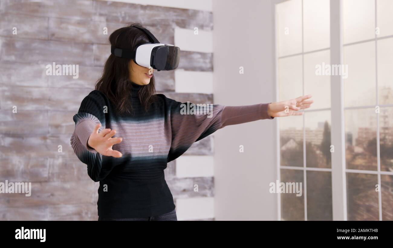 Beautiful female home designer using virtual reality goggles inside of ...
