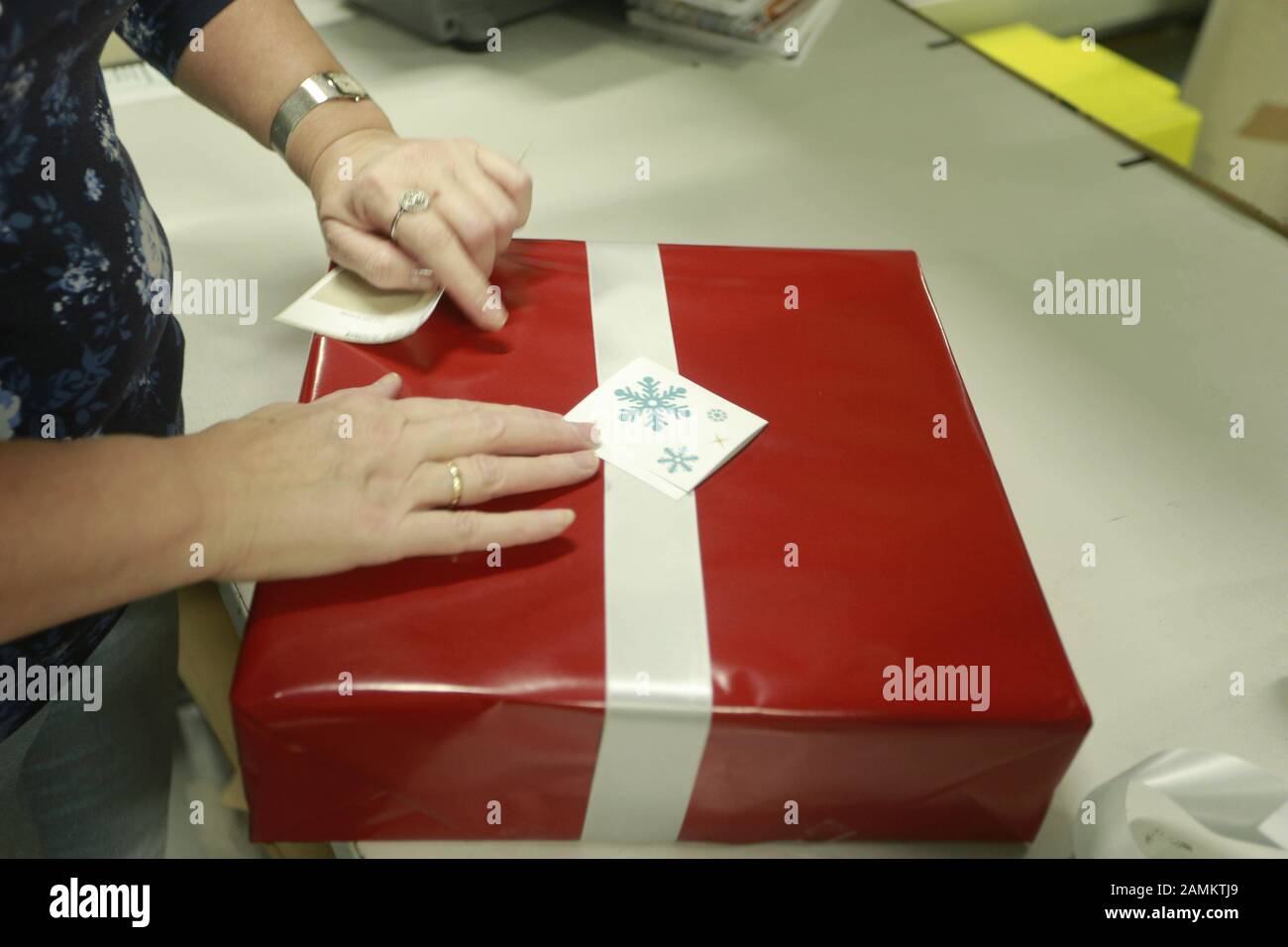 Packing a consignment of goods as a gift at the Amazon logistics centre ...