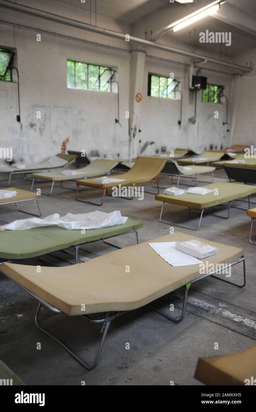 Camp beds in a former garage of the barracks hi-res stock photography ...