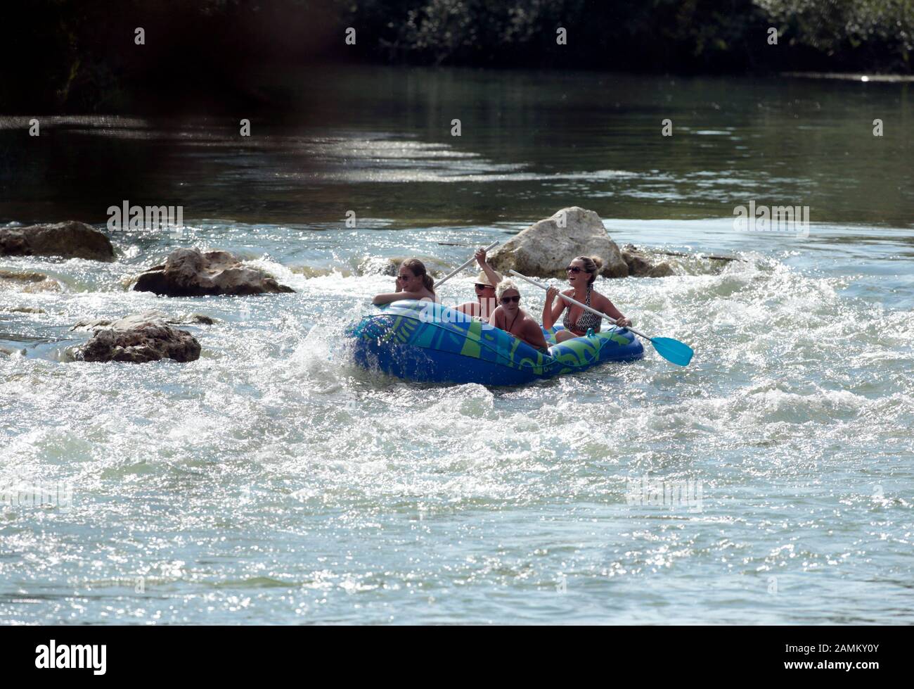 A rubber dinghy crosses the new bottom threshold in the Amper River ...