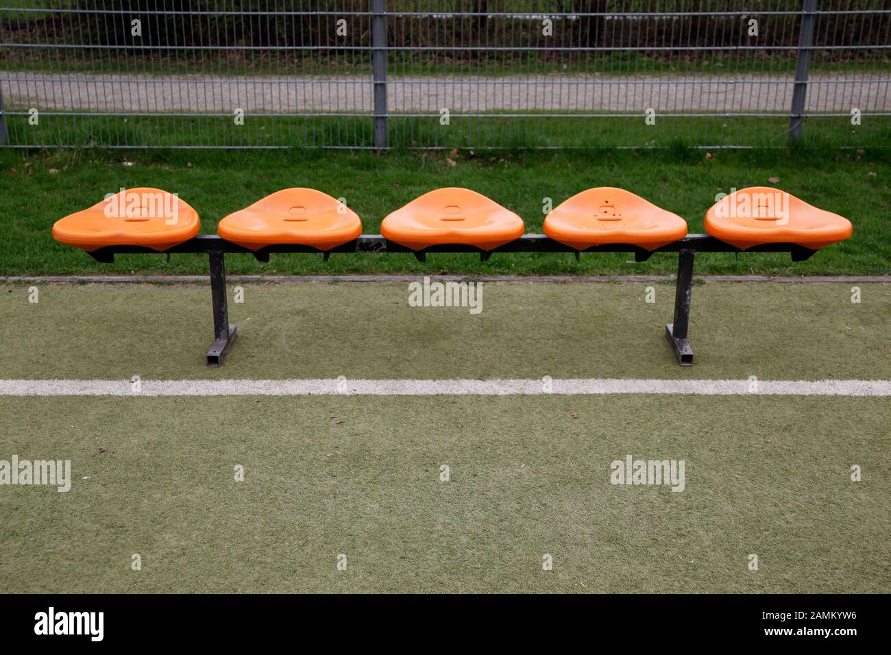 Benches in front of the pitch of the artificial turf pitch in the ...