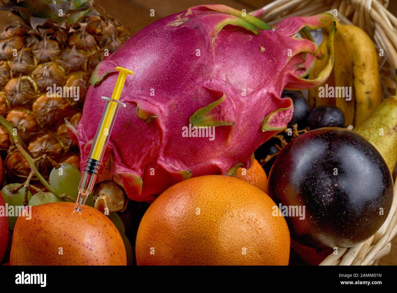 Injecting with syringe conservation products into fruits Stock Photo ...