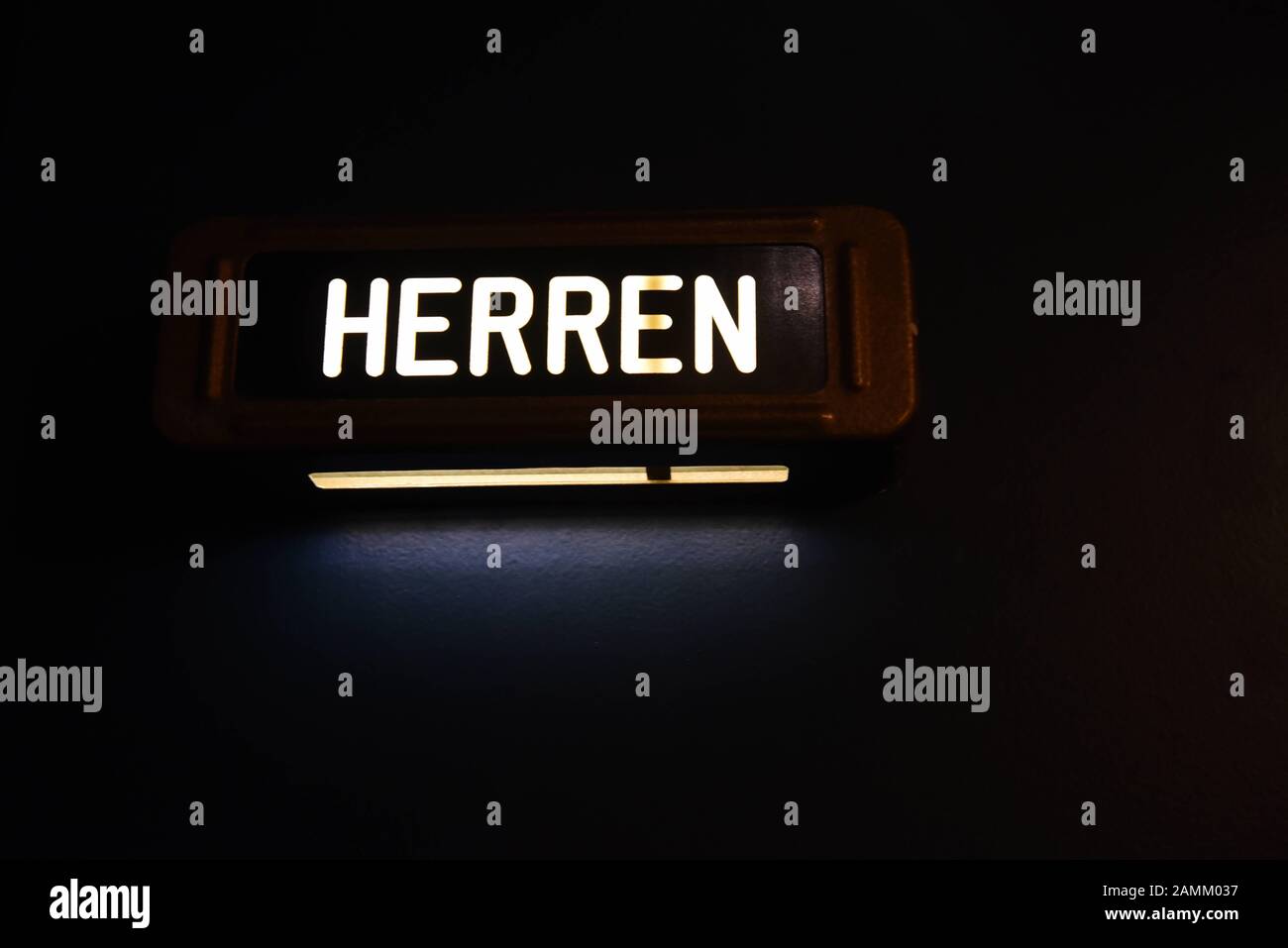 Illuminated lettering at the entrance to the men's toilet in the ...