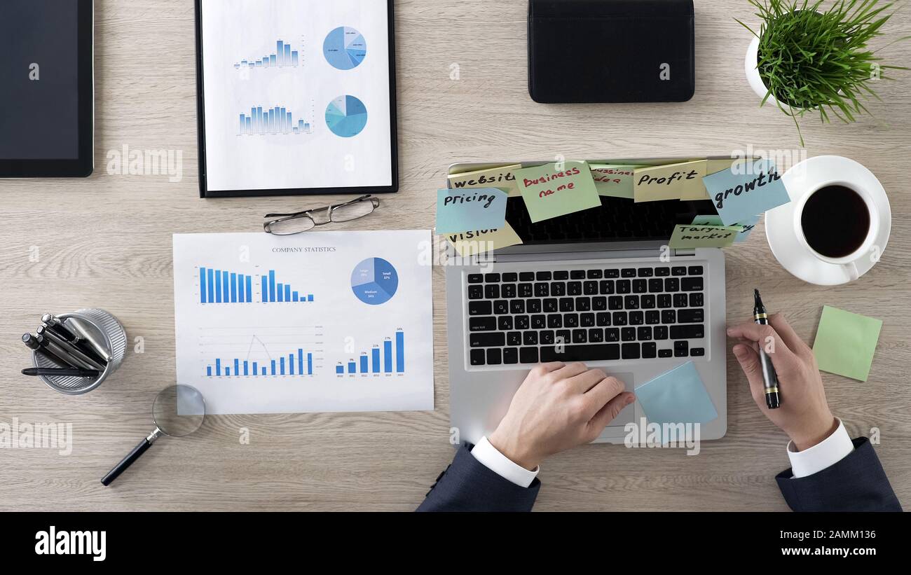 Office worker writing idea on sticker and brainstorming at workplace ...