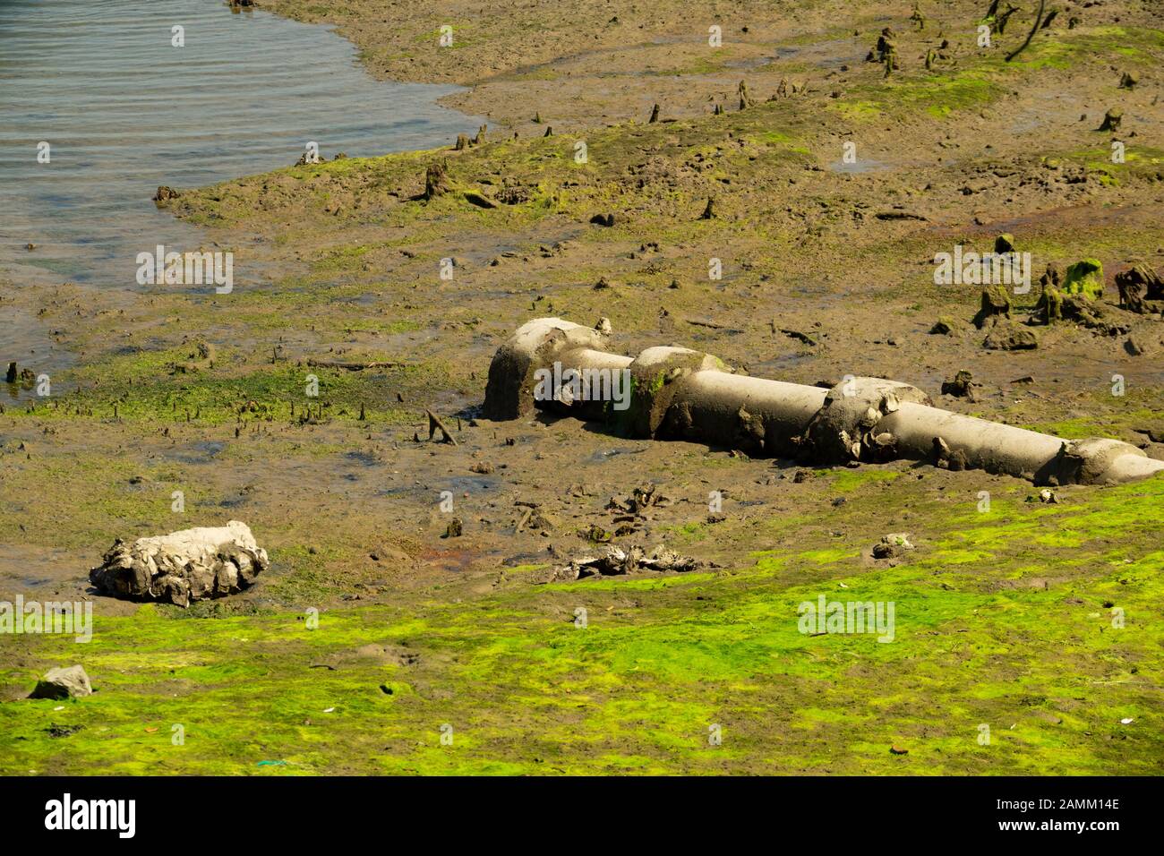 Mud and drainage system pipe to the river Stock Photo - Alamy