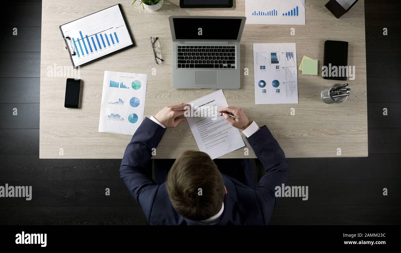 Man reading business contract, concluding agreement with partner, top ...