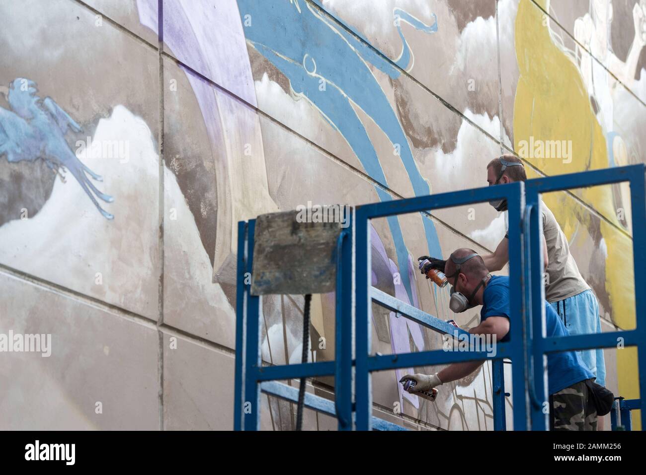 Graffiti artists embellish the outer wall of the new refugee workshop ...