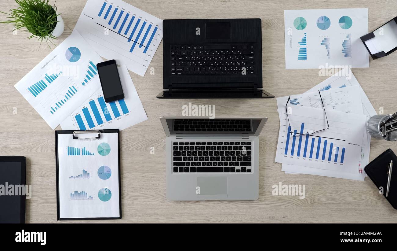 Two laptops opposite each other, small company office lack of space and ...