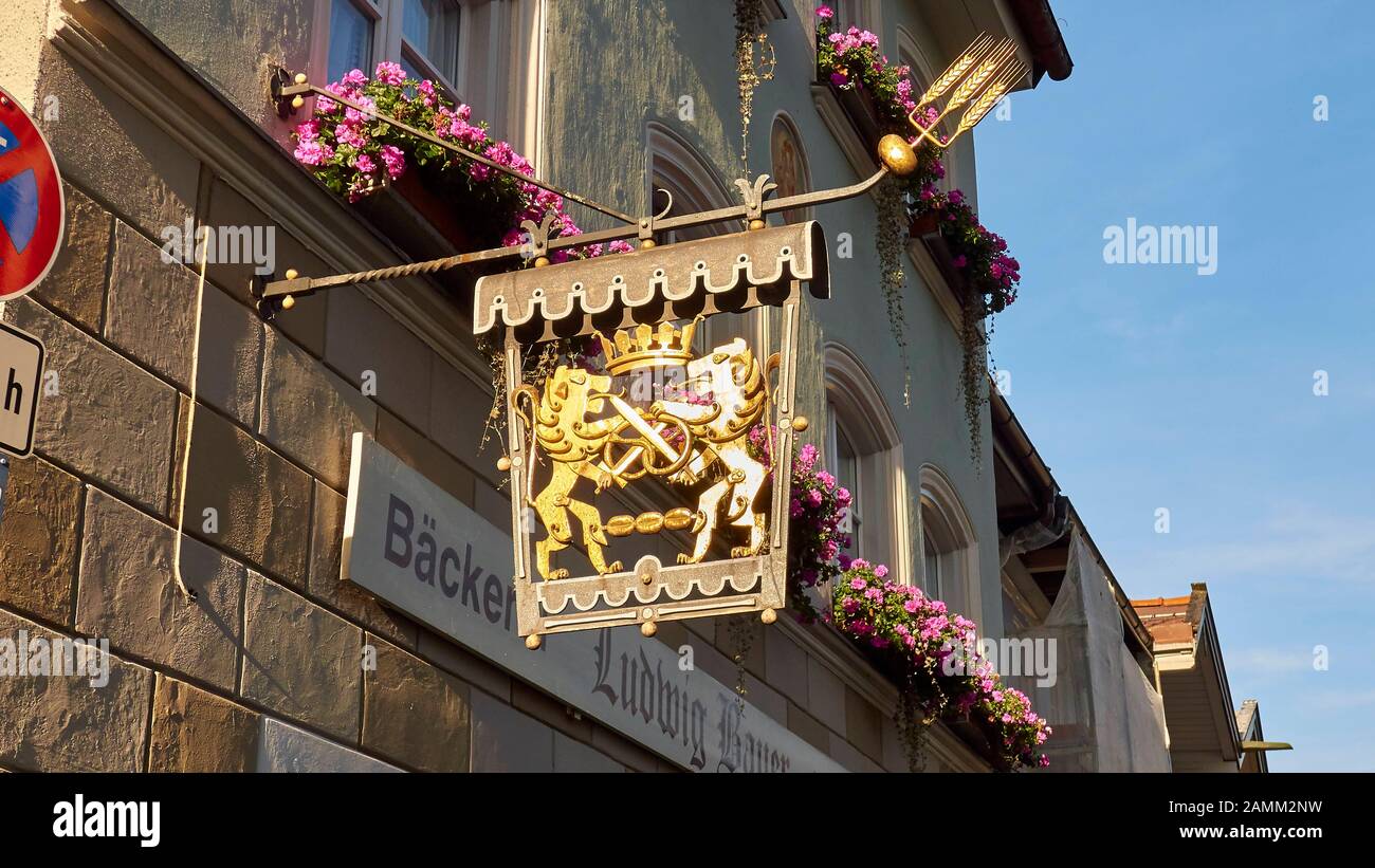 golden guild sign of a bakery in Bad Tölz, a crown, lions with crossed ...