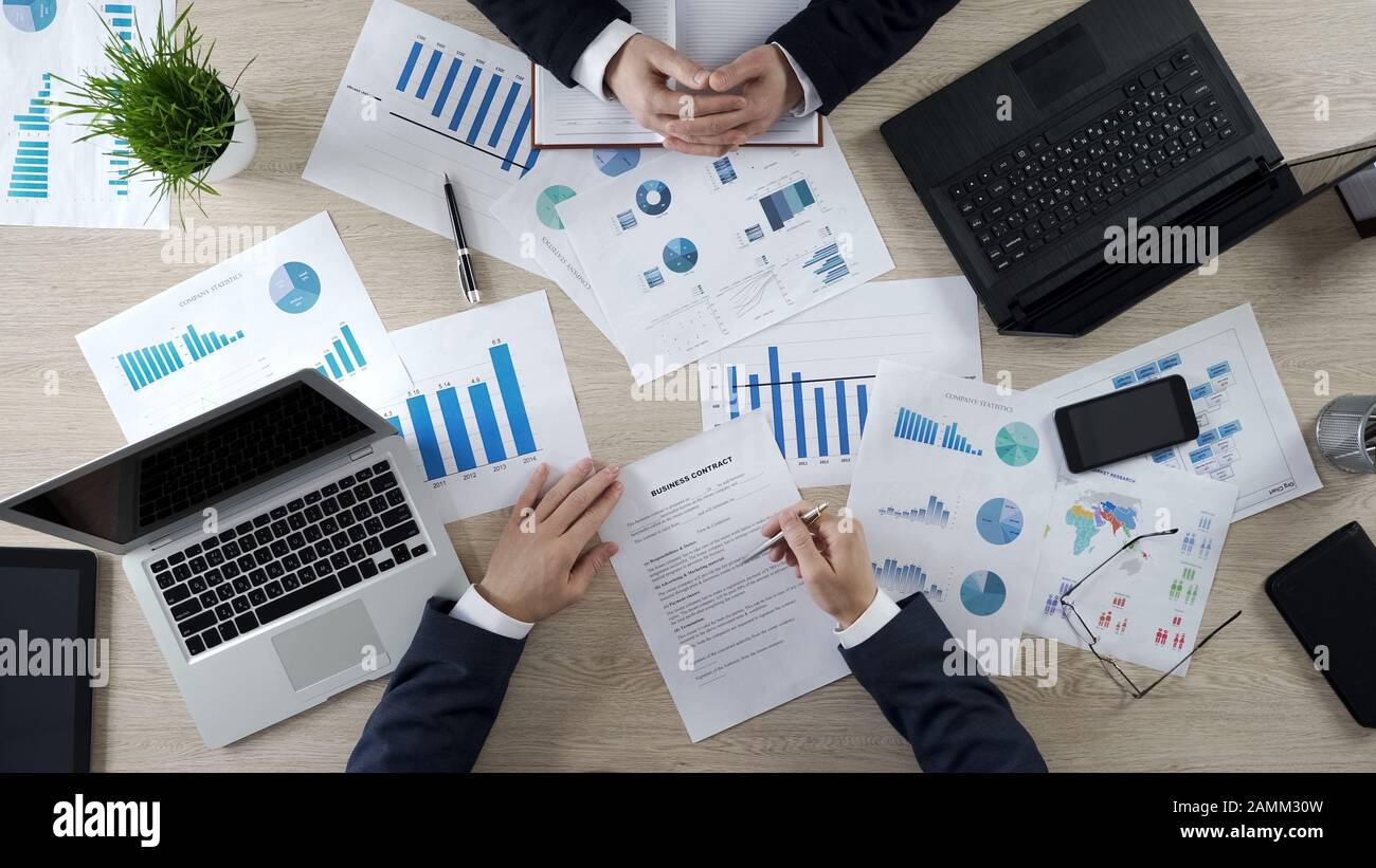 Man signing business contract, partners shaking hands, start of ...