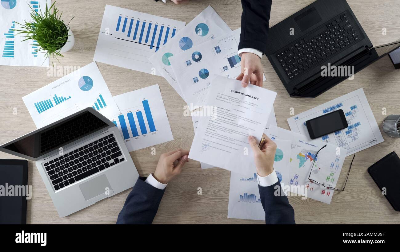 Top view of partner taking business contract for signing, bilateral ...