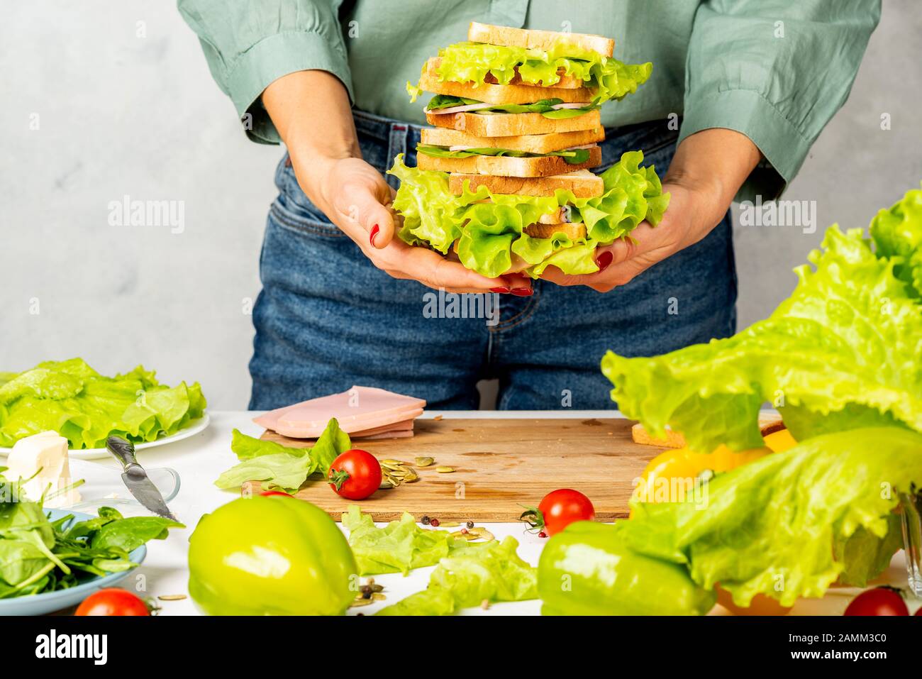 Woman holds a stack of sandwiches in her hands on the kitchen Stock ...